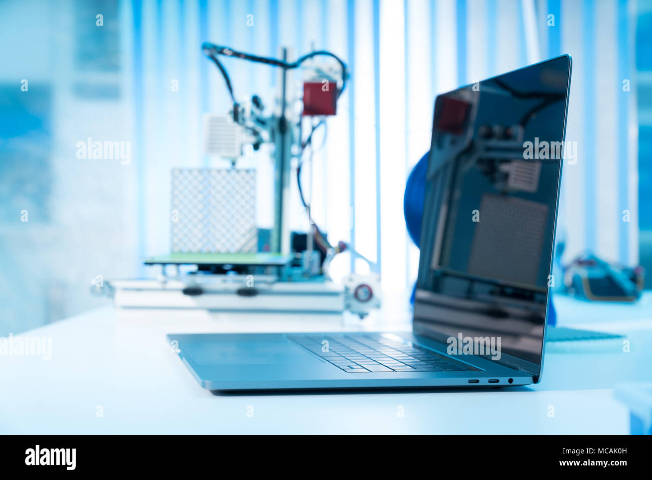 Computer and 3d printer on table in industrial design lab Stock Photo ...