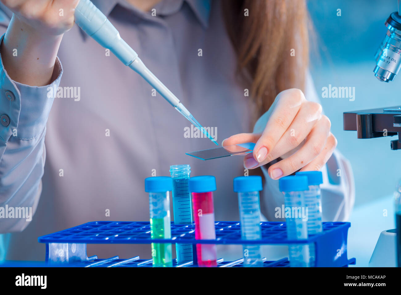 Blood sample on microscope slide. Researcher Analyzing Microscope Slide ...