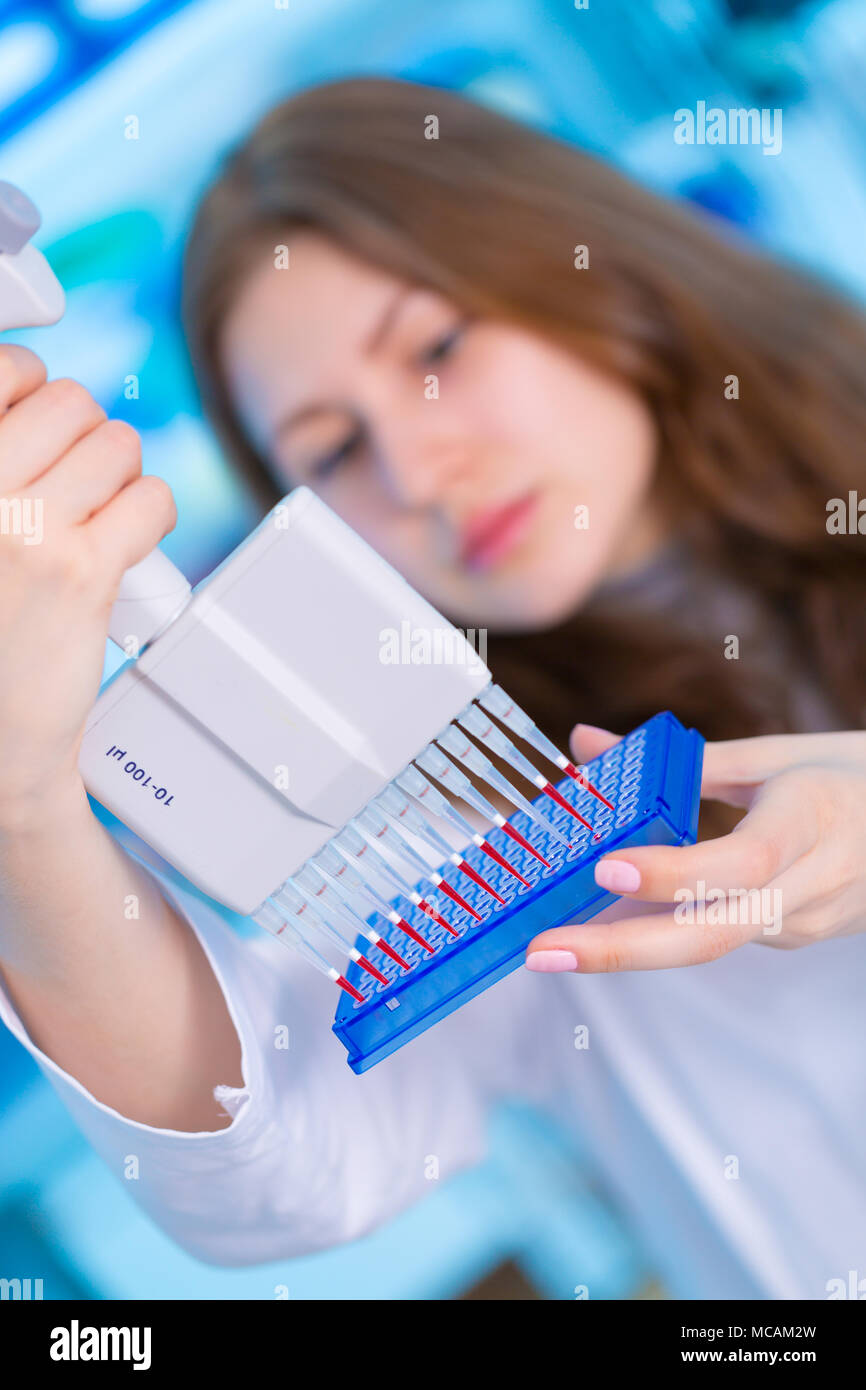 laboratory female assistant with pipette Stock Photo - Alamy