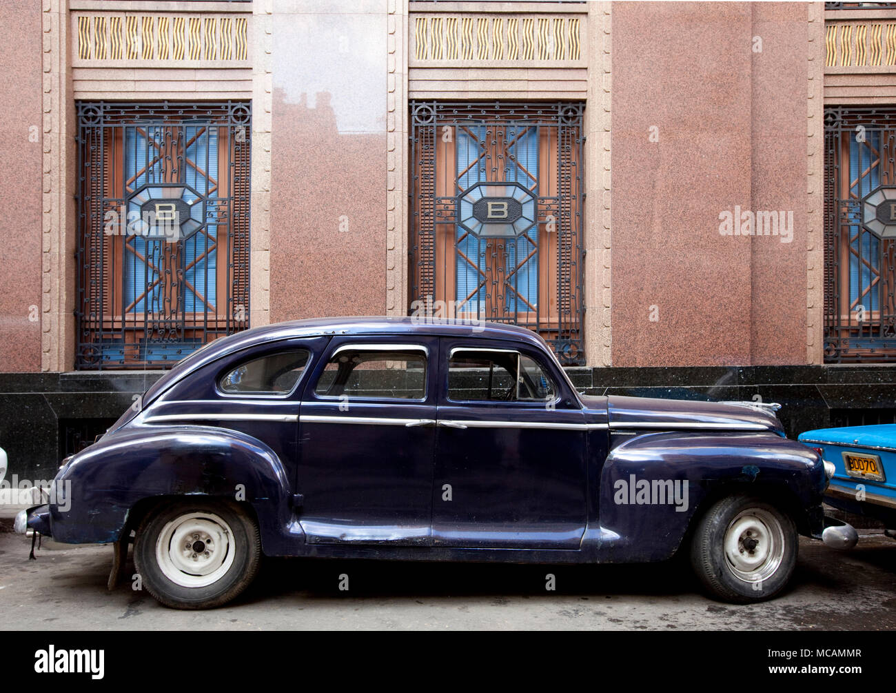 Vintage car parked next to the Bacardi Rum building in Havana, Cuba ...