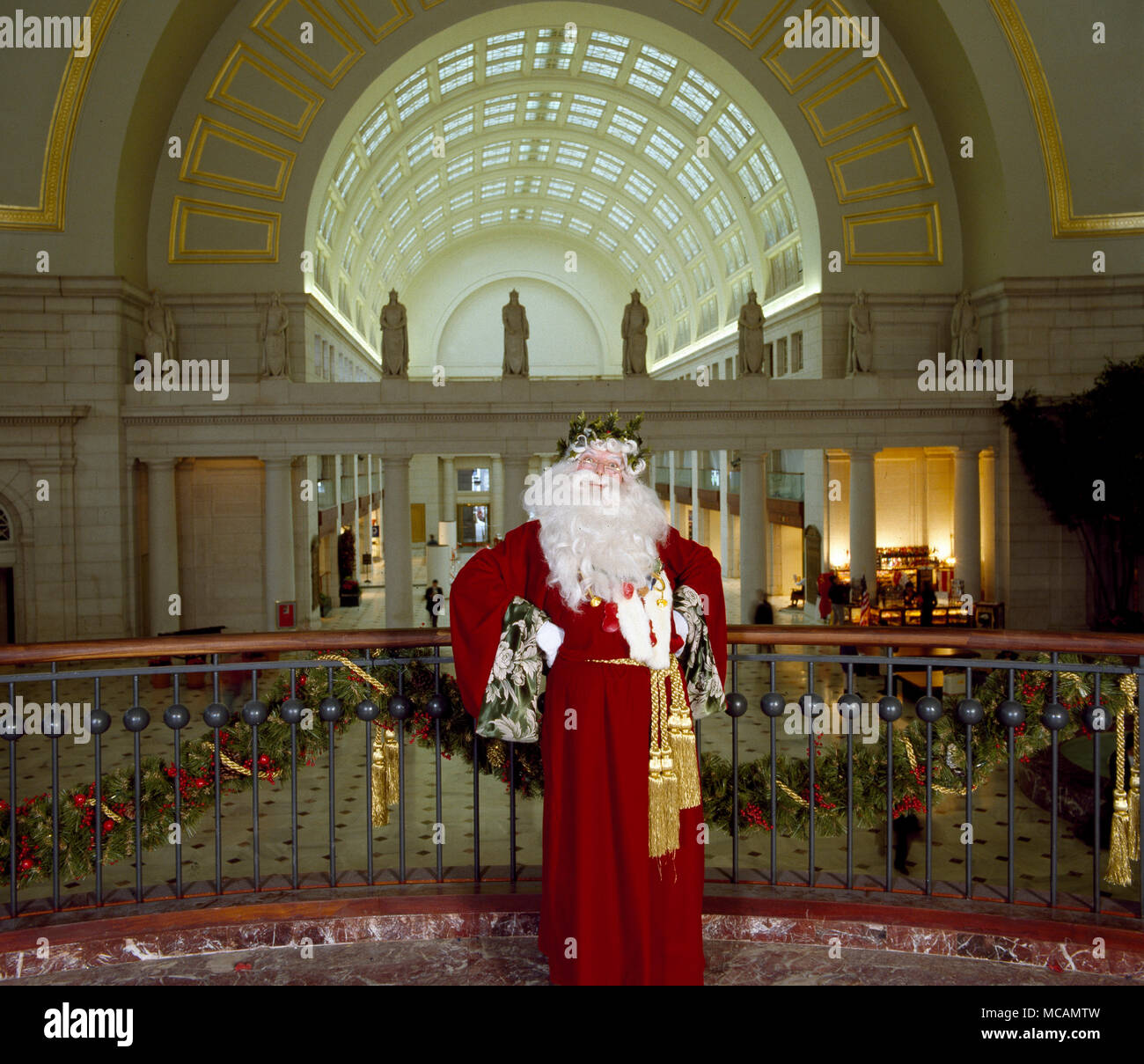 A Santa Claus smiles from the stairs of the library Stock Photo - Alamy