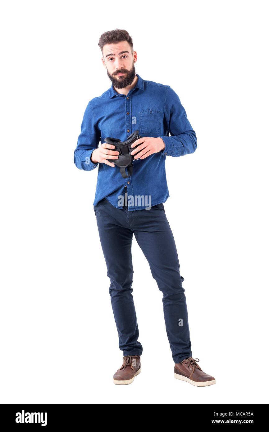 Confused skeptical indifferent business man holding virtual reality ...