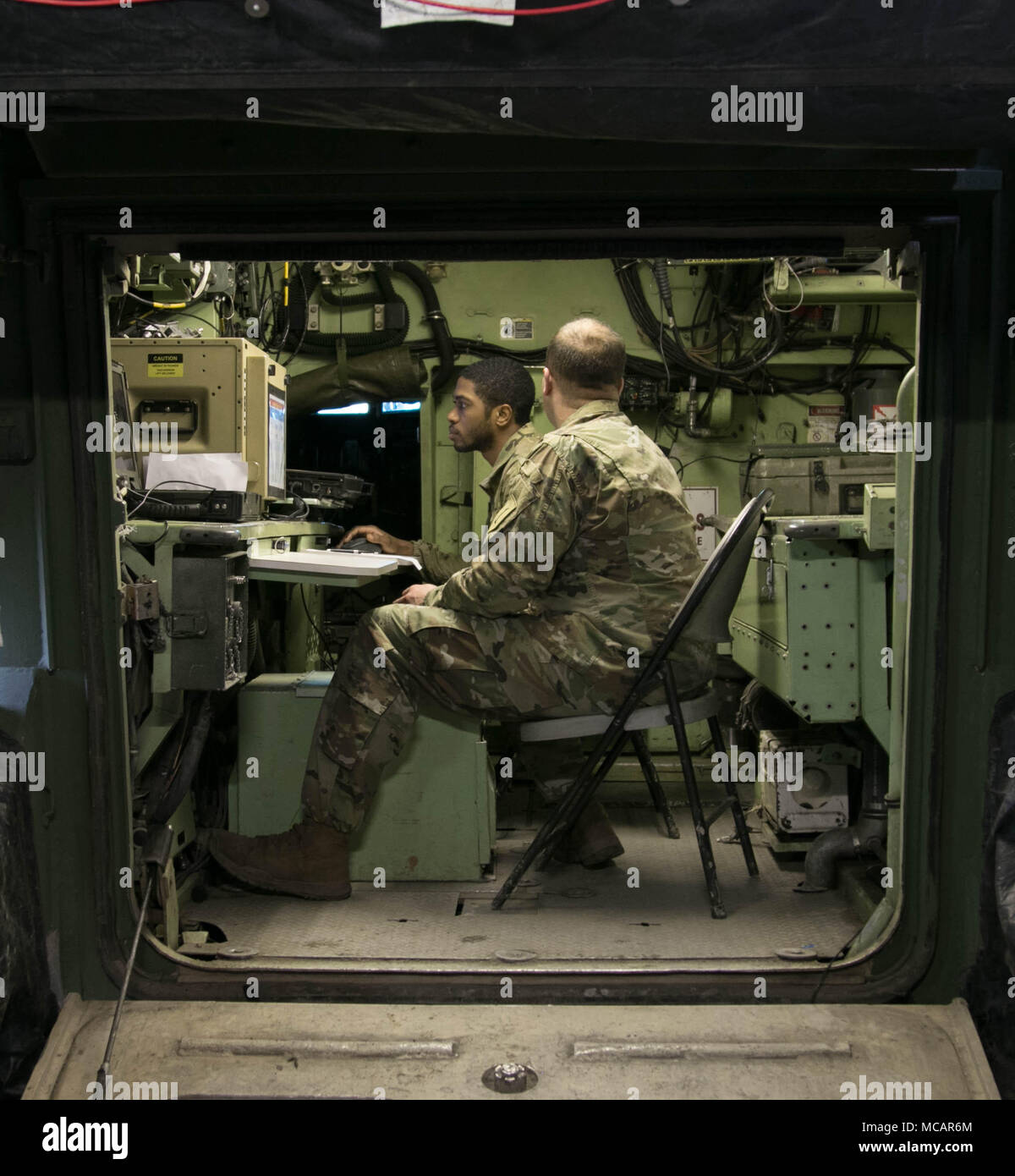 Sgt. Darryl Griffith (looking at computer screen) tracks, manages and ...