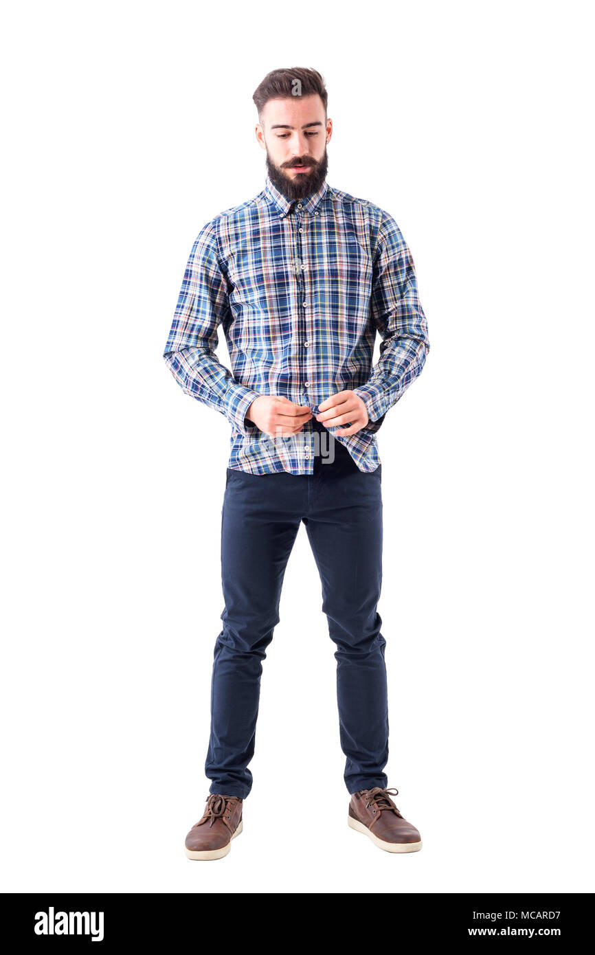 Relaxed cool bearded hipster buttoning plaid checkered shirt looking ...