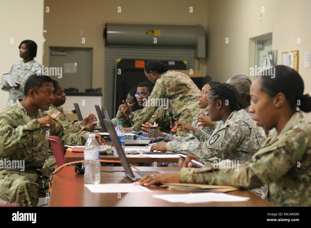 Soldiers of the 104th Troop Command sit in different stations awaiting ...