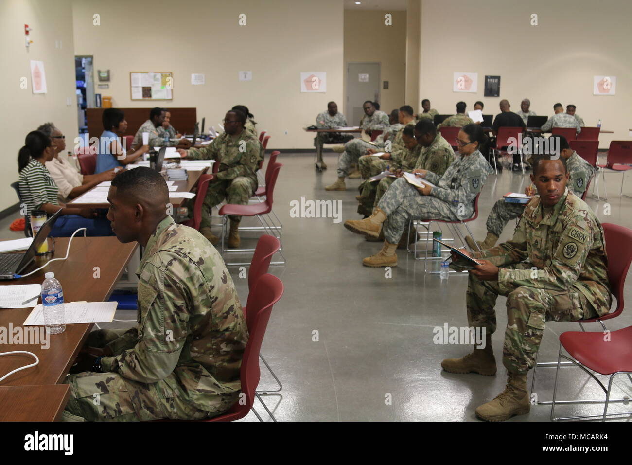 Soldiers of the 104th Troop Command sit in different stations awaiting ...