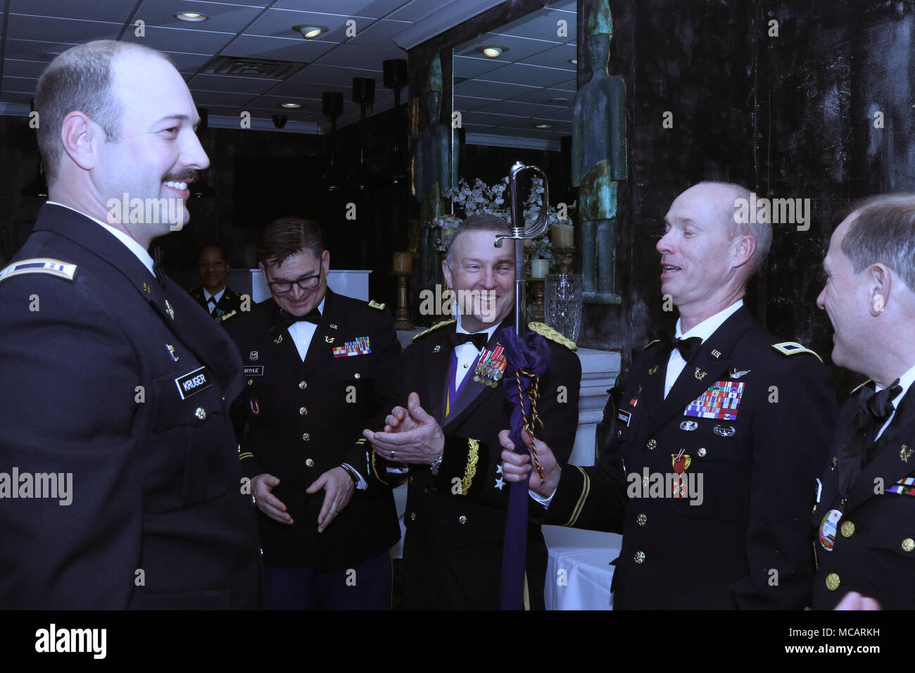 Col. Lee Thaggard, military trial judge, is given a saber at the ...