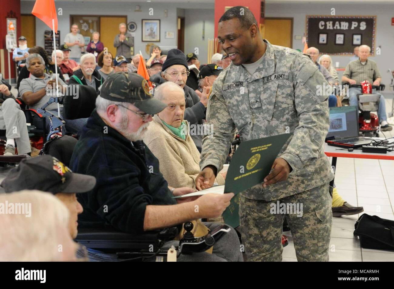 Marine Sgt. (Ret.) John Cain receives an award and coin during a ...