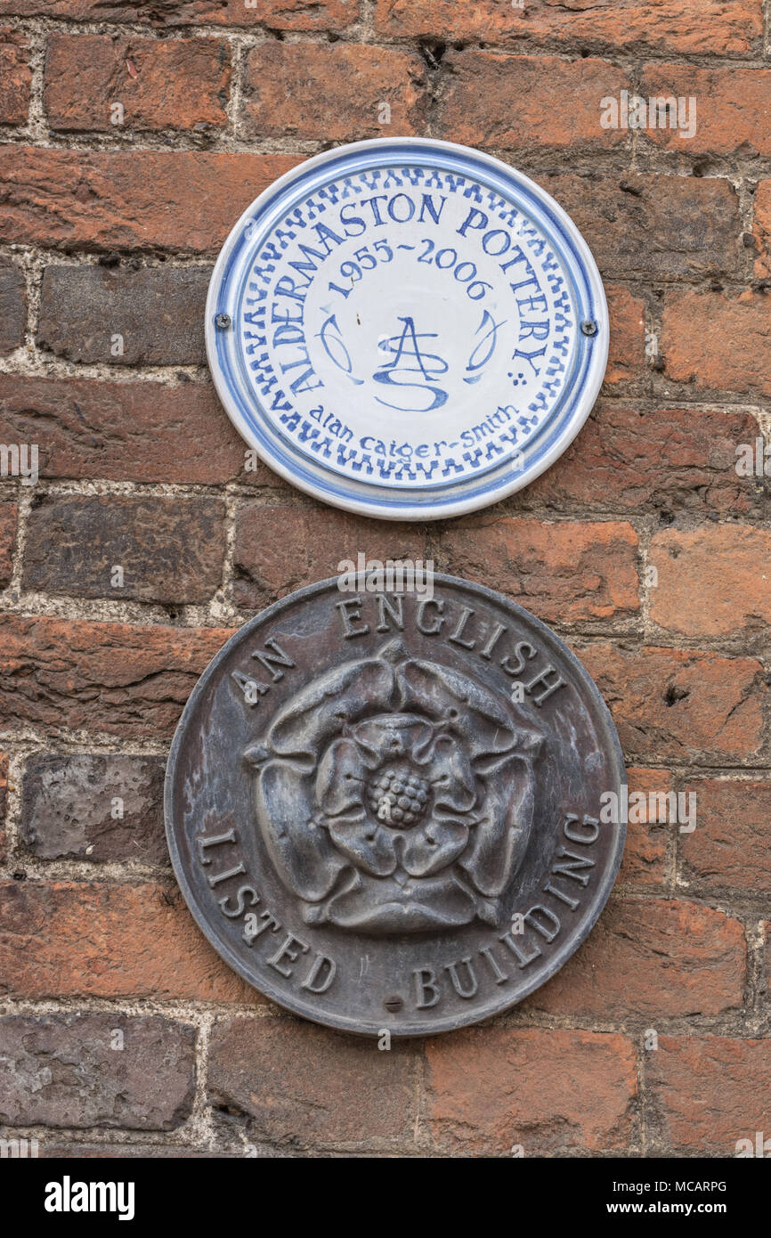 Plaques on the wall outside the old pottery in Aldermaston village in ...
