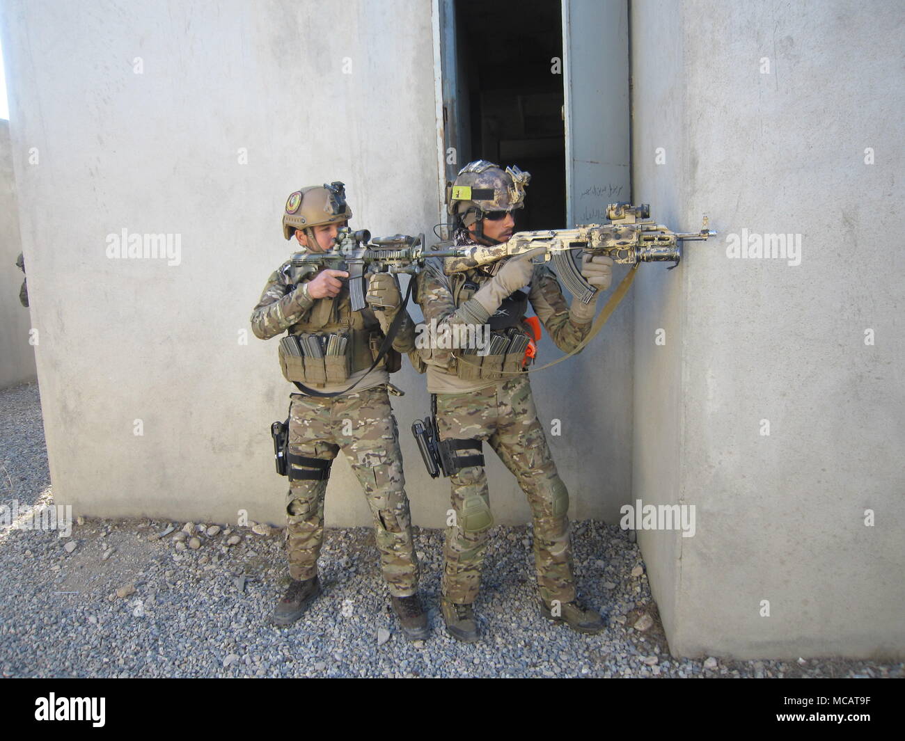 Crisis Response Unit 222 operators prepare to enter a building during a ...