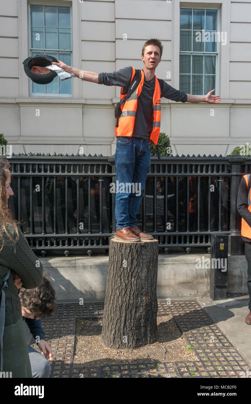 London, UK. 14th April 2018. Guy stands on a stump at the corner of ...
