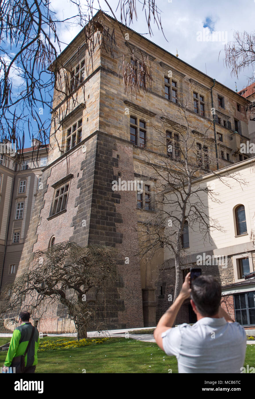 10 April 2018, Czech Republic, Prague: Tourists walk past the side wing ...