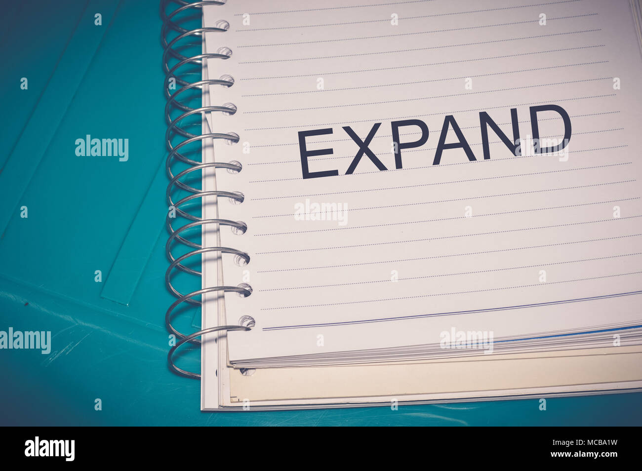 Expand word written on white paper Stock Photo - Alamy