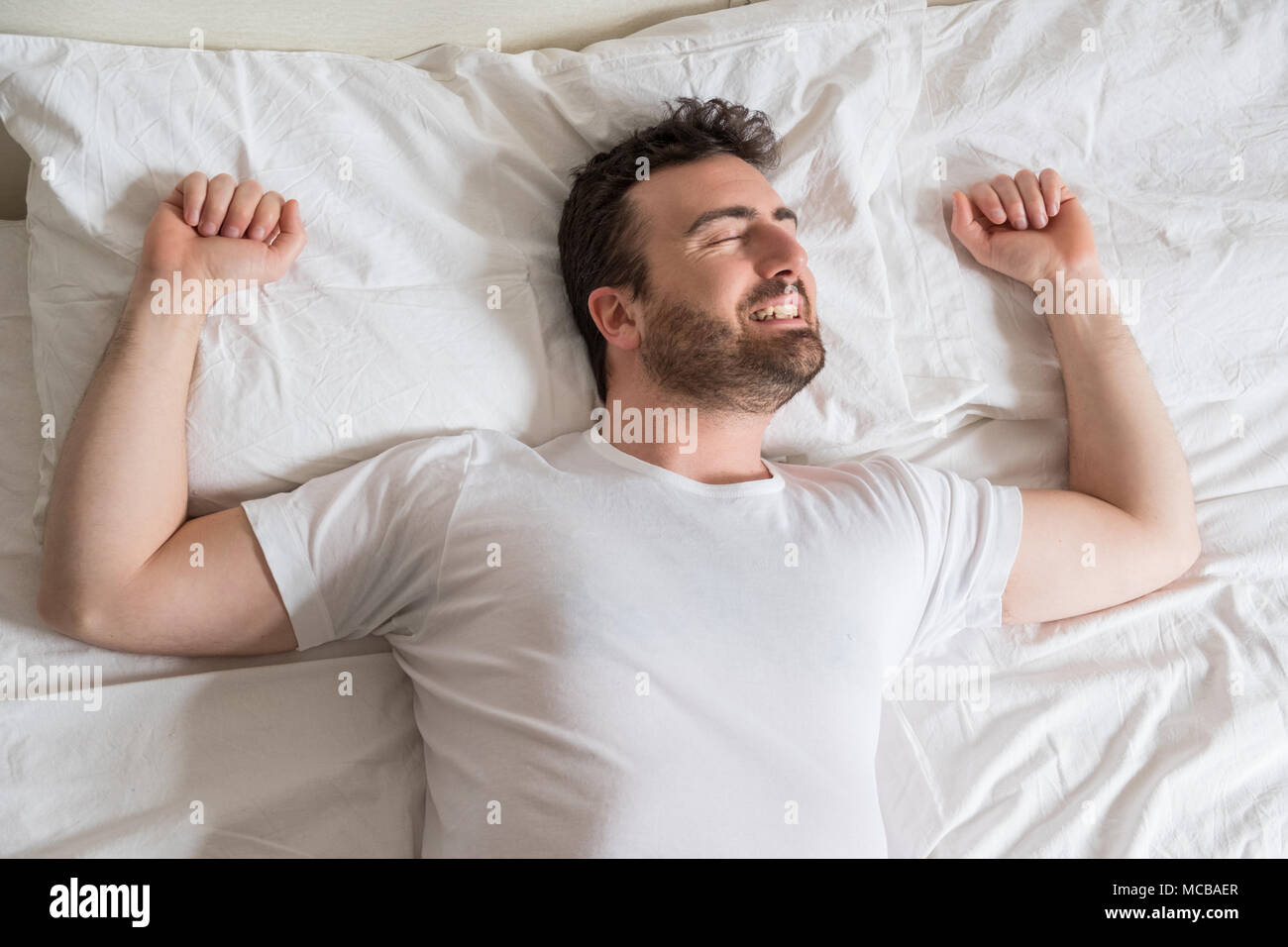 Handsome man sleeping in bed hi-res stock photography and images - Alamy