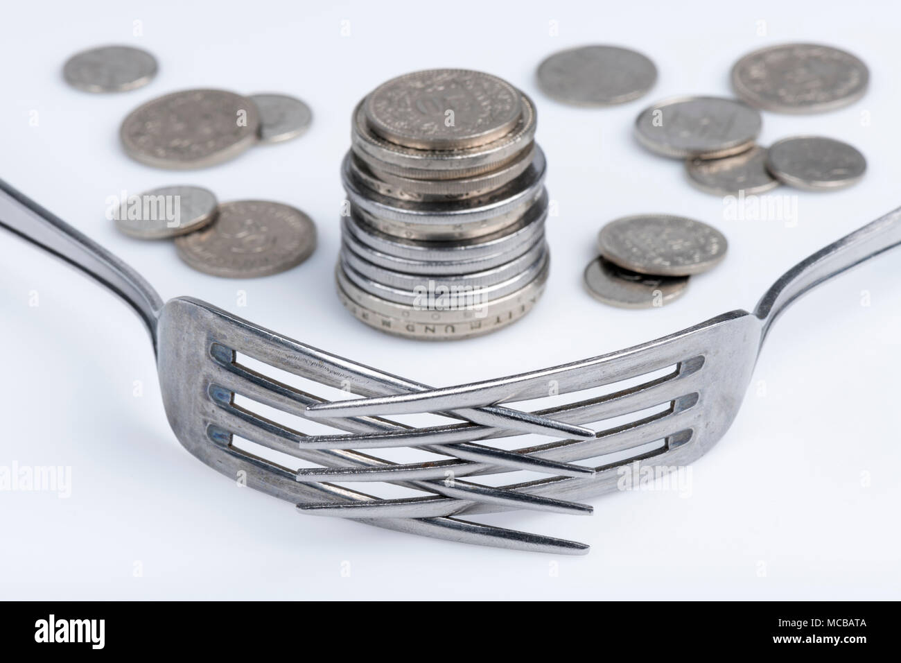 Conceptual representation of financial greed by two forks and coins ...