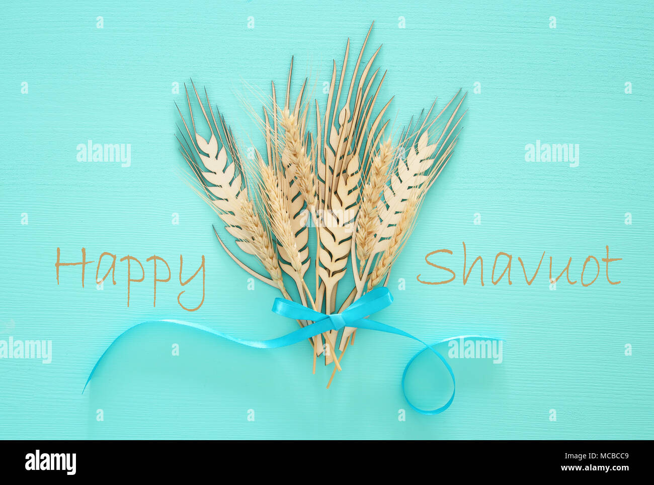top view of wooden wheat crop decoration over mint background. Symbols ...