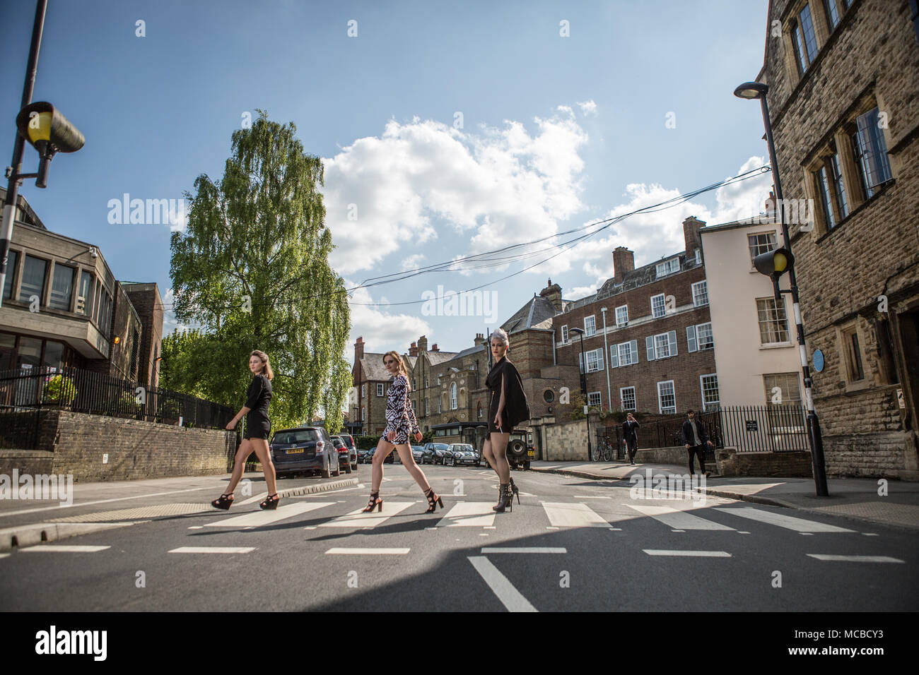 three ladies in heels cross zebra crossing Stock Photo - Alamy