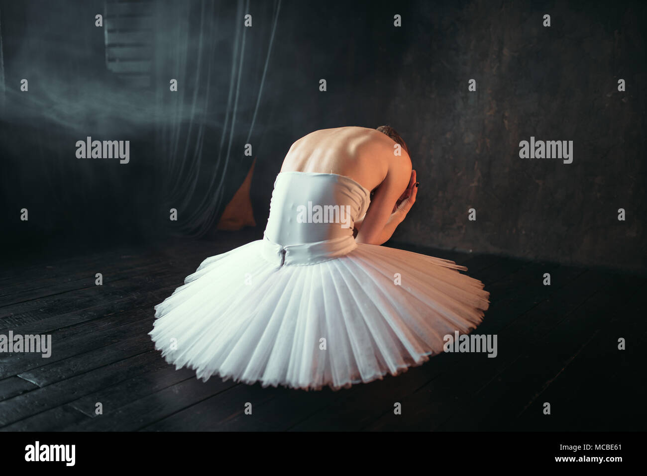 Ballet dancer sitting on stage, back view Stock Photo - Alamy