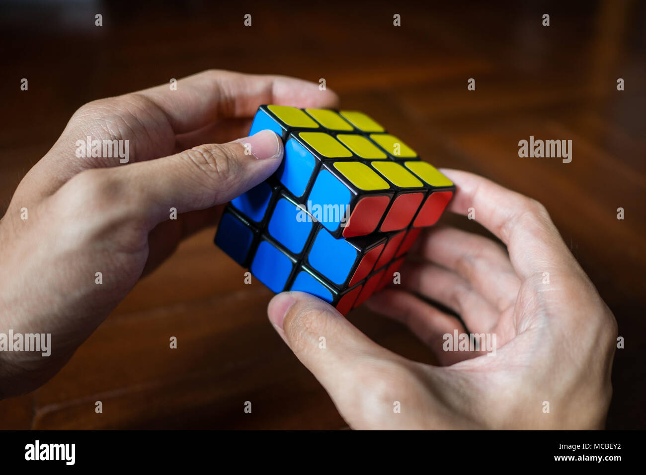 Bangkok, Thailand - March 28, 2018 : A man solving Rubik's cube Stock Photo - Alamy