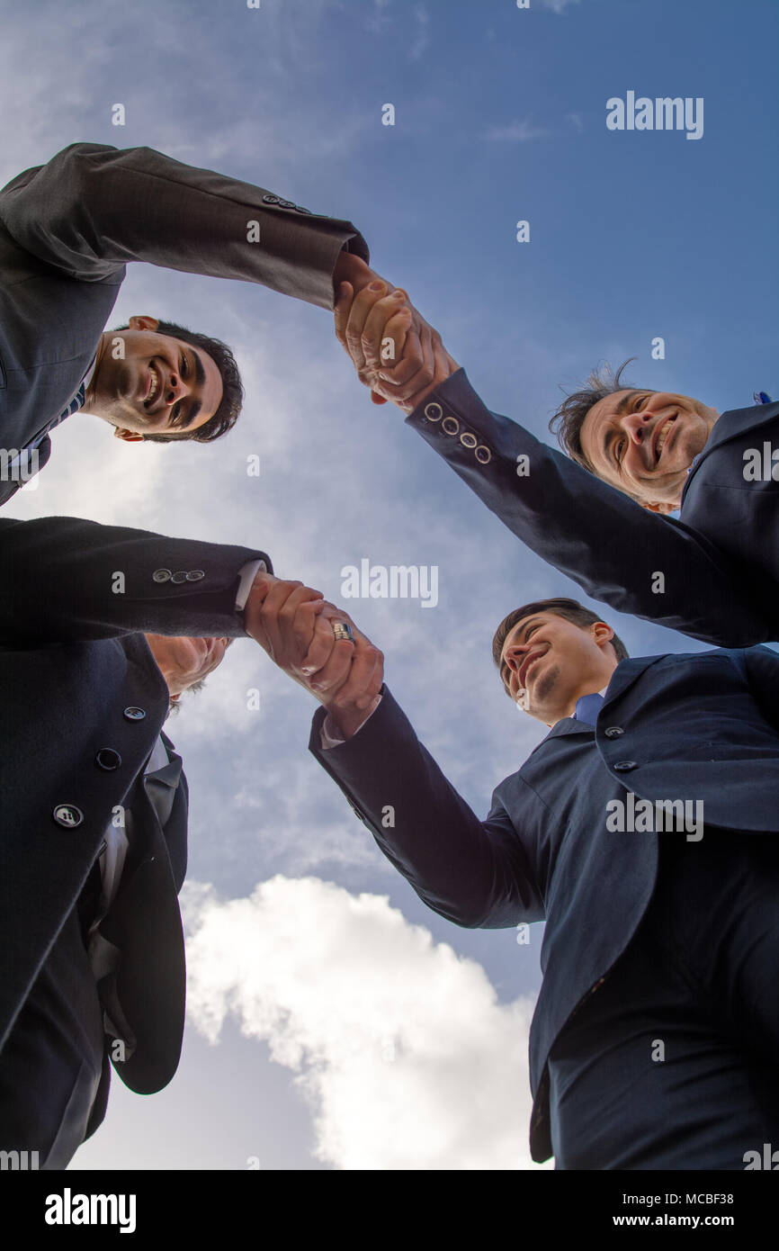 Group of Business man with suit in outdoor ambient holding hands Stock ...