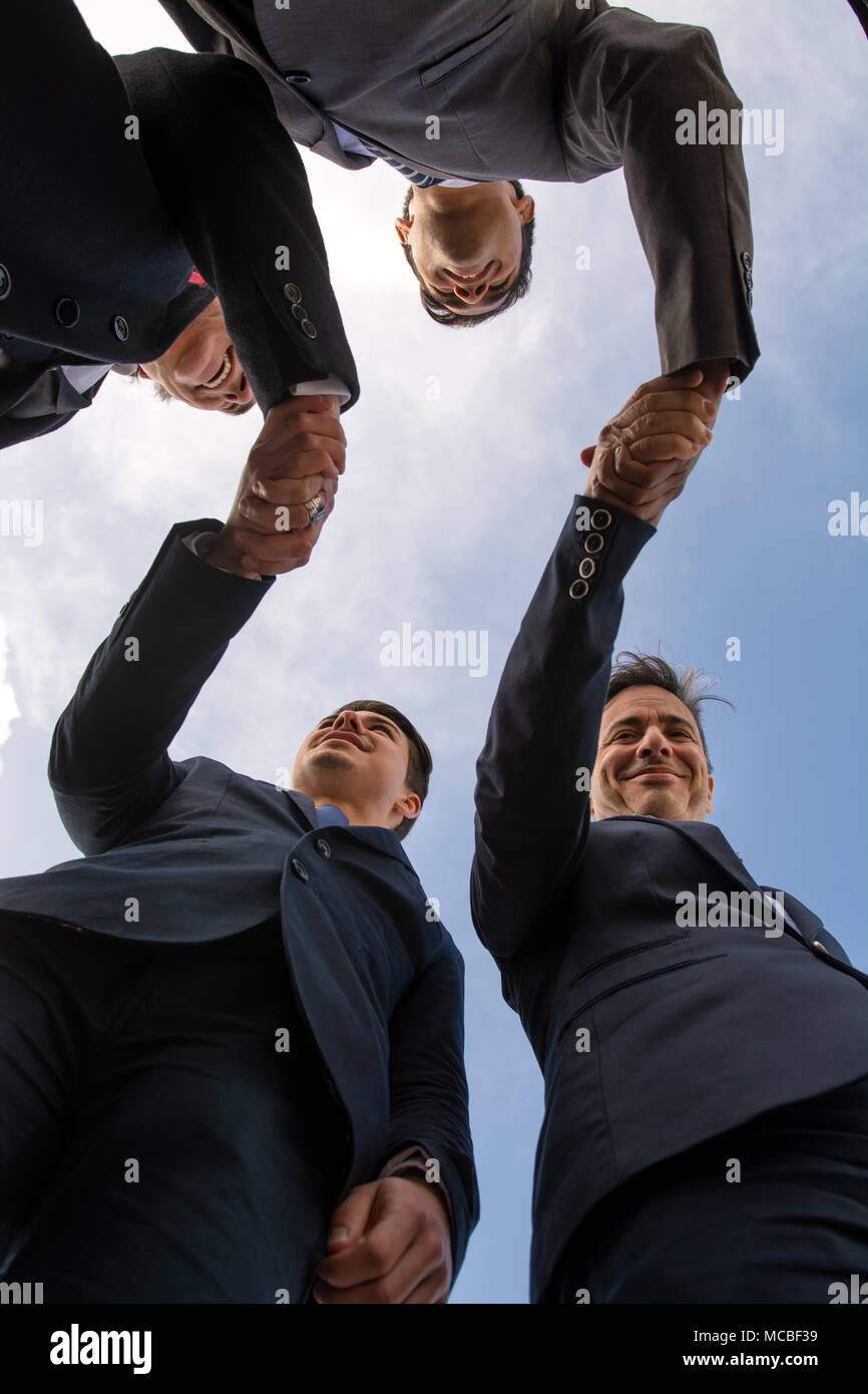 Group of Business man with suit in outdoor ambient holding hands Stock ...