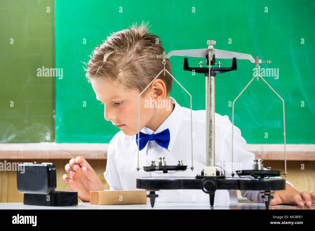 School boy learning scales and weights at the blackboard Stock Photo ...