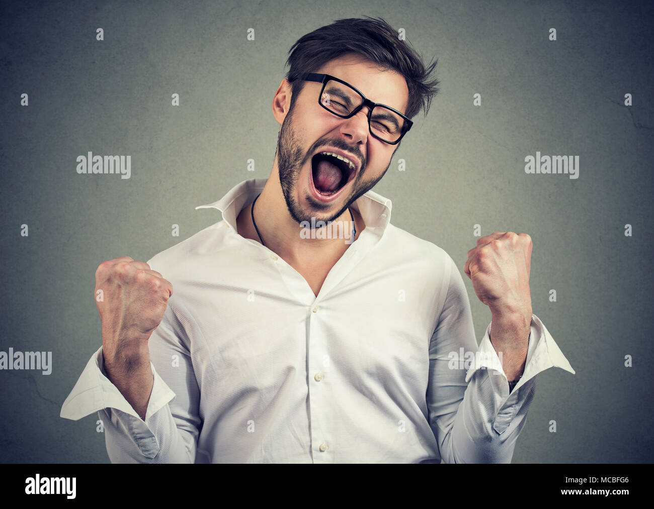 Happy successful man winning, fists pumped celebrating success isolated ...
