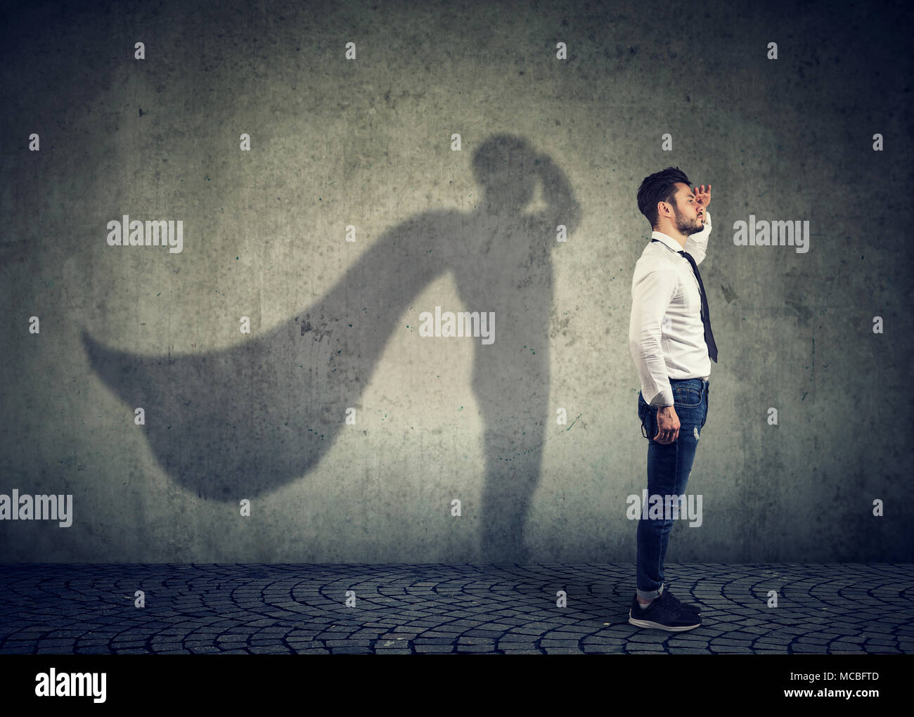 Side view of a man imagining to be a super hero looking aspired Stock ...