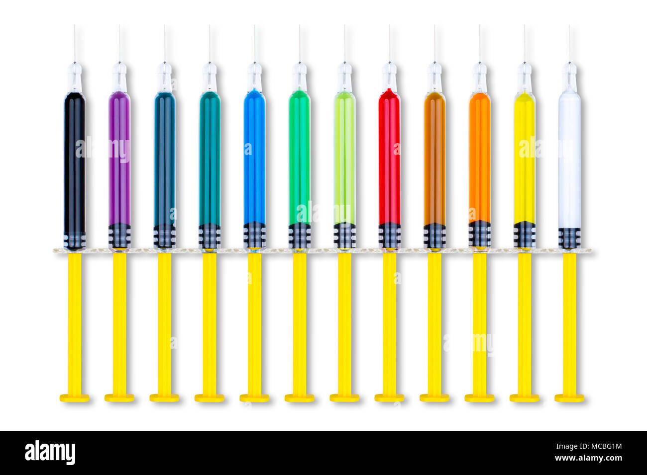 Multiple syringes with needles, filled with various colours of medicine ...