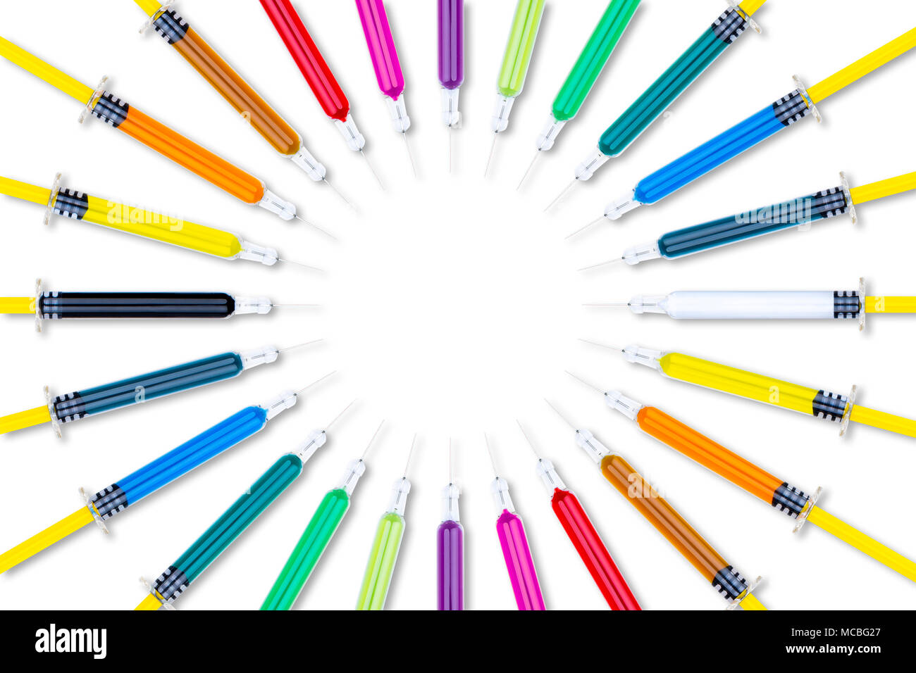 Multiple syringes with needles, filled with various colours of medicine ...