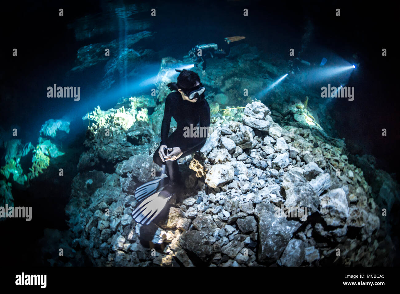Freediver checking out the darkness of Cenote Tajma-Ha, Mexico Stock ...