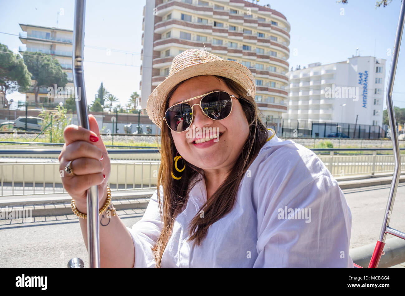 A lady wearing a sun hat and sunglasses poses for a photograph Stock ...