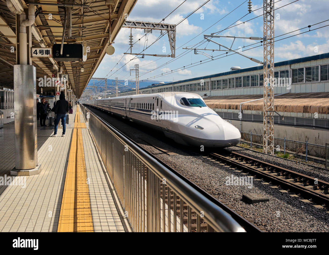 Shinkansen high-speed train travels through Mishima Station, Shizuoka ...