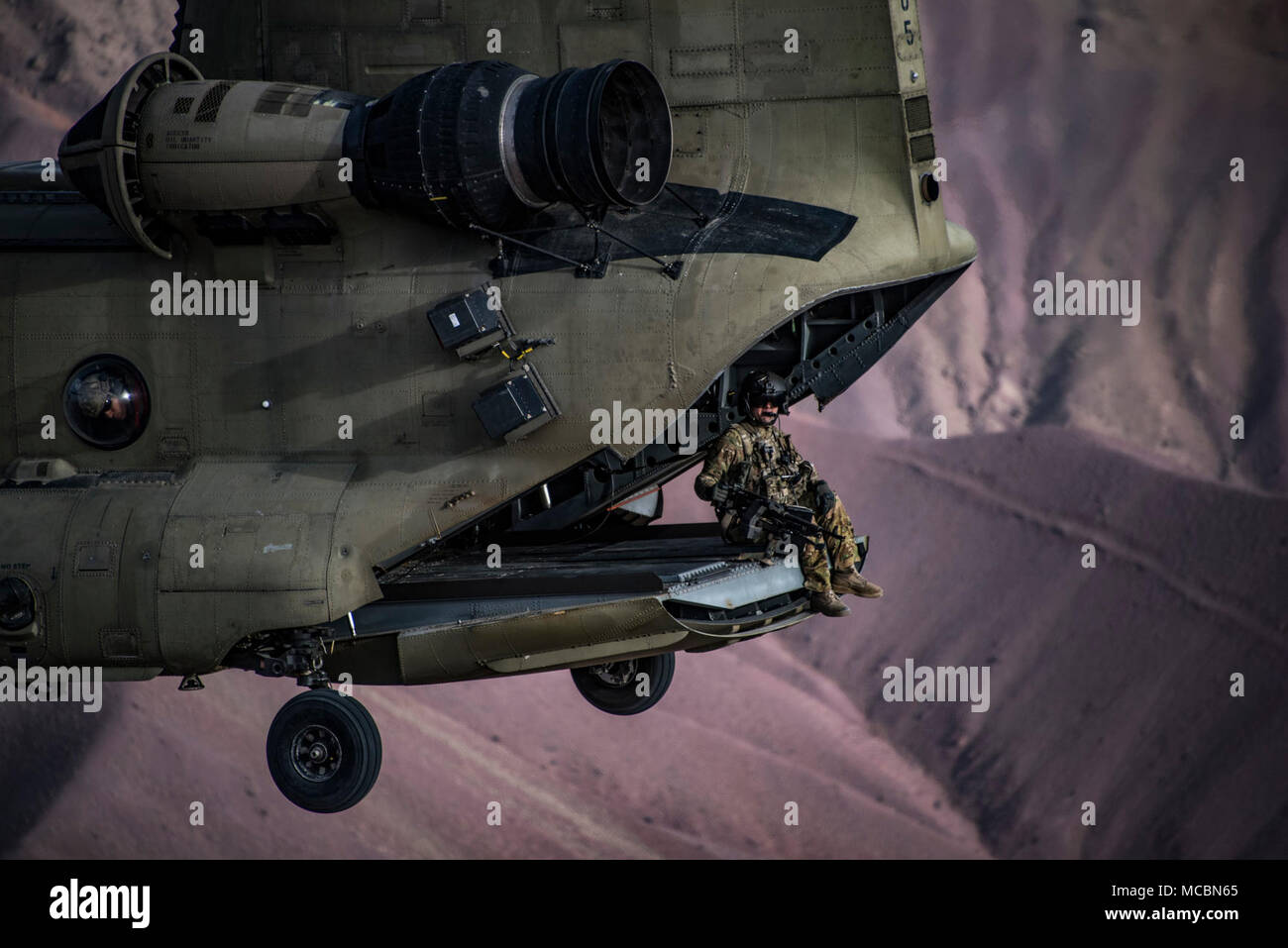 A U.S. Army Task Force Brawler CH-47F Chinook flight engineer sits on ...