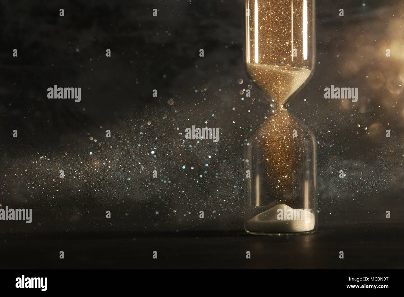 Image of hourglass as time passing concept over black background for ...