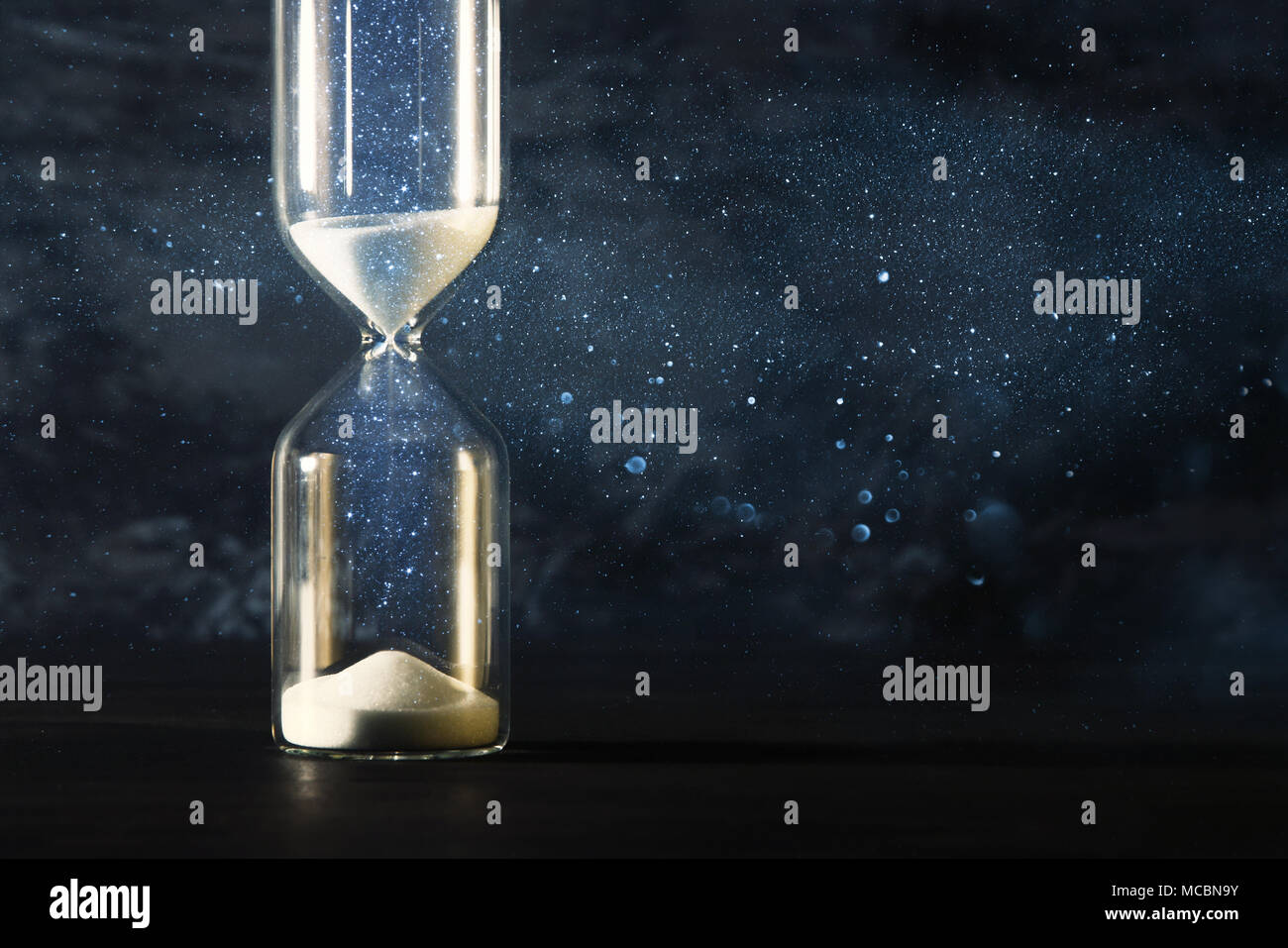 Image of hourglass as time passing concept over black background for ...