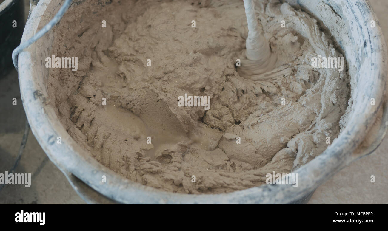 mixing concrete plaster with electric mixer, wide photo Stock Photo - Alamy
