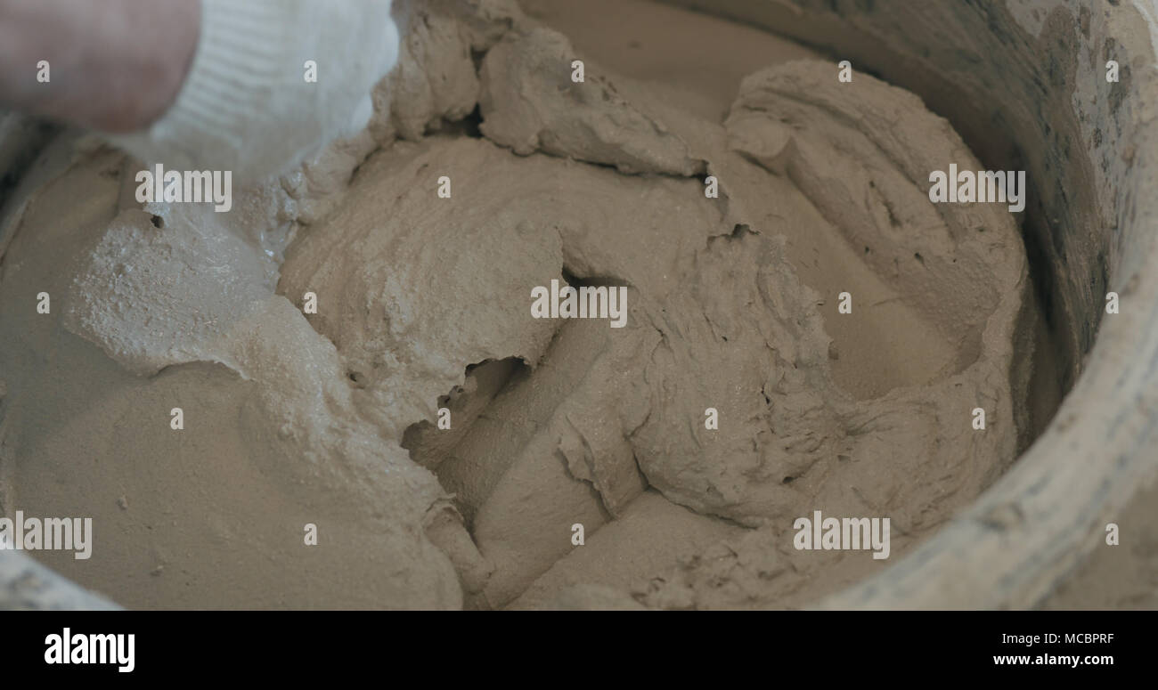 mixing concrete plaster with spatula, wide photo Stock Photo - Alamy