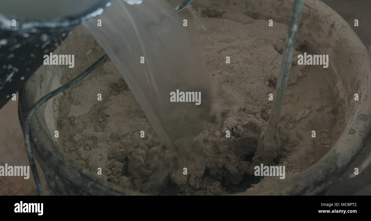 pouring water into concrete plaster in bucket, wide photo Stock Photo ...