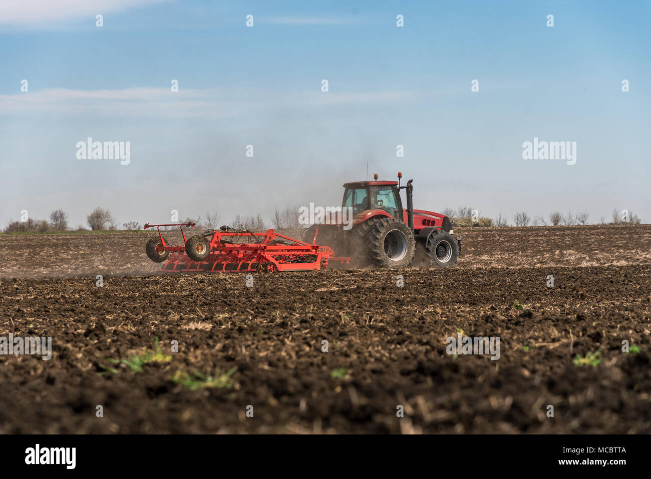 Tractor plowing fields. Preparing land for sowing in autumn Stock Photo ...
