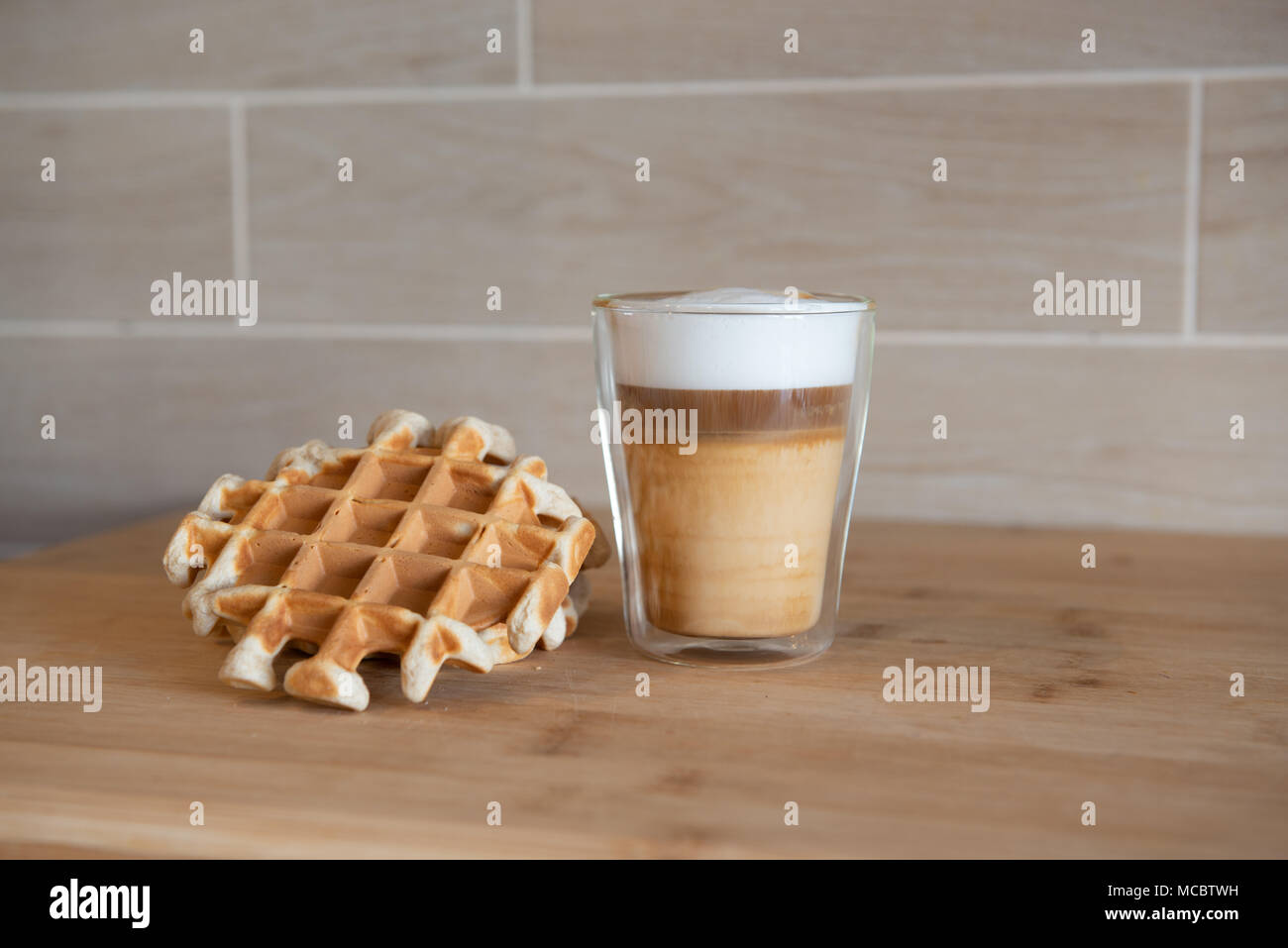 Glass cups of multilayer coffee with mini stroopwafel, syrupwaffles ...