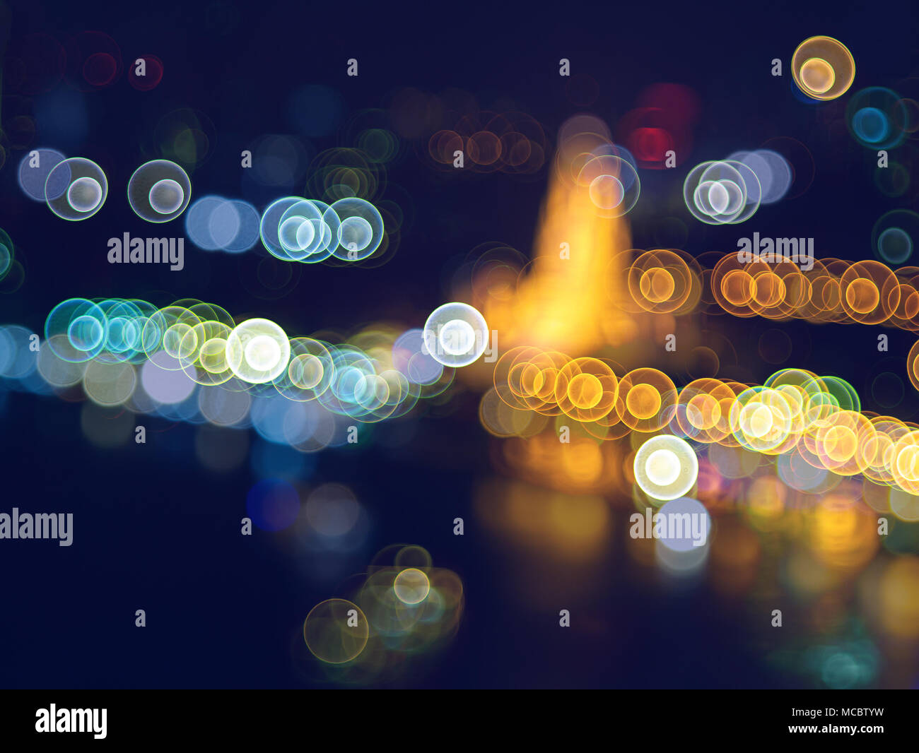 Defocus high view of the light of Wat Arun and building near Chaopraya ...