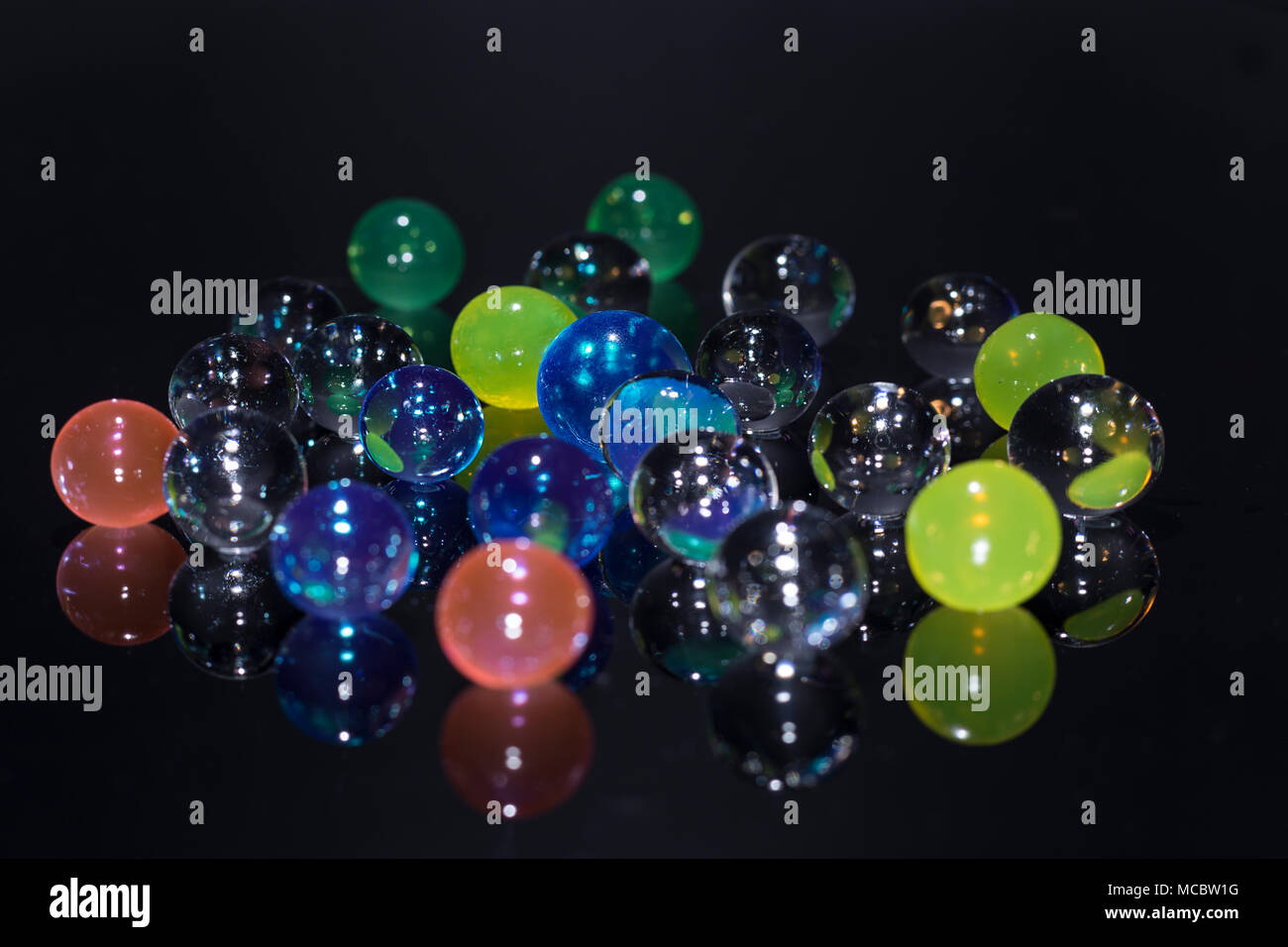 Colored water balls on black background Stock Photo - Alamy