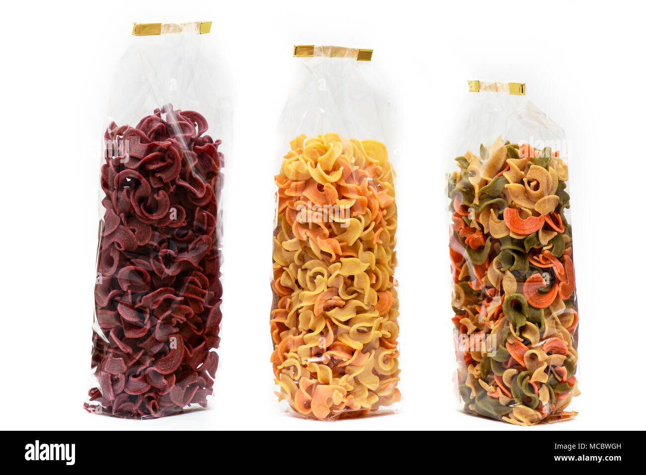 Dried three pasta in bag front view. Colorful vegetable pastas on ...