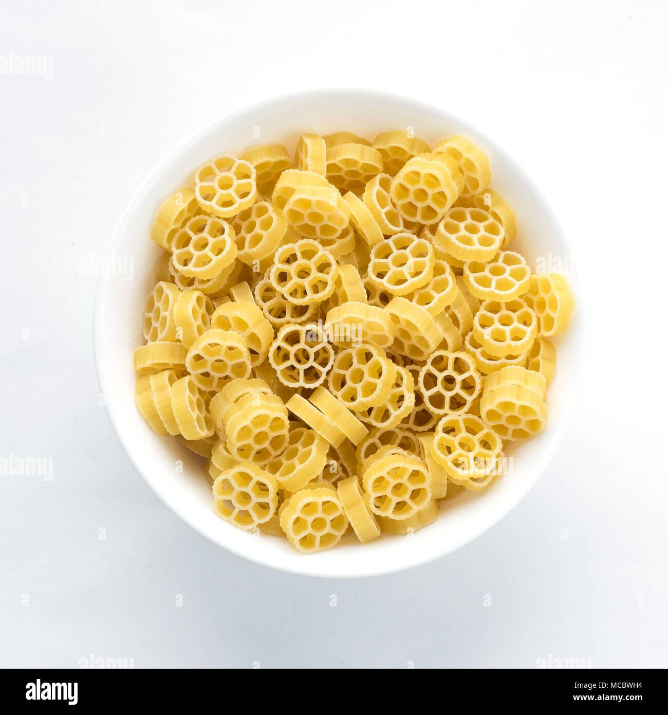 Macaroni ruote pasta in white cup on white isolated background, in the ...