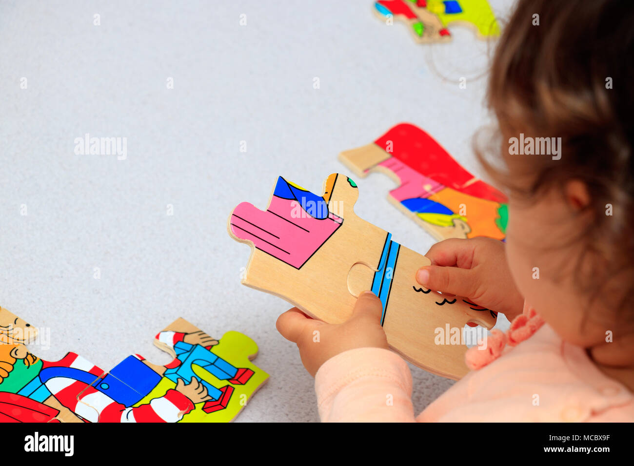little girl playing with puzzle, early education background Stock Photo ...