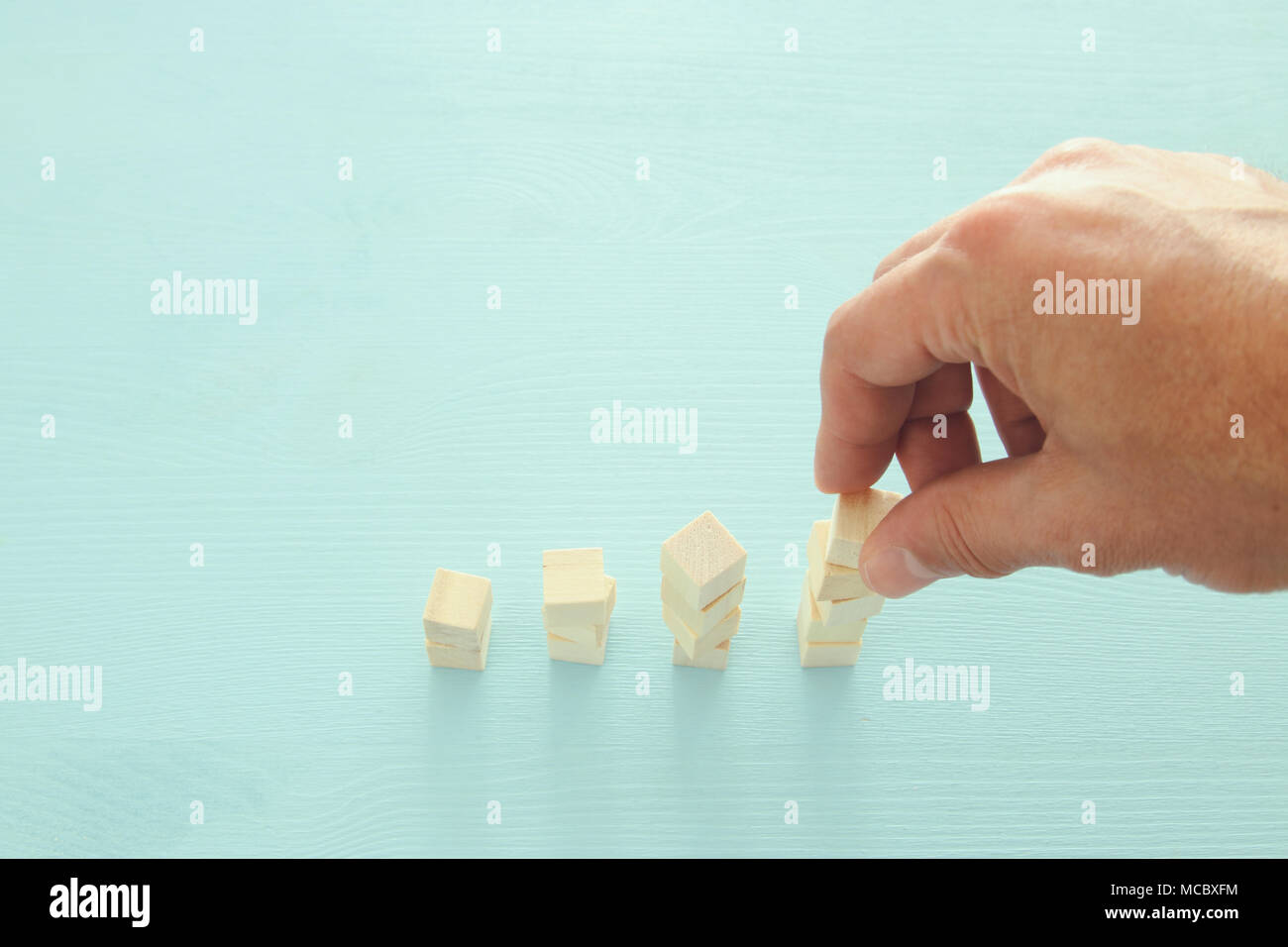 Hand arranging wood block stacking as chart or ladder. concept for ...