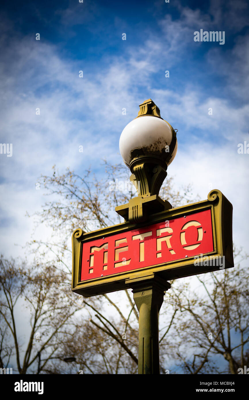 Paris Metro sign against blue sky Stock Photo - Alamy