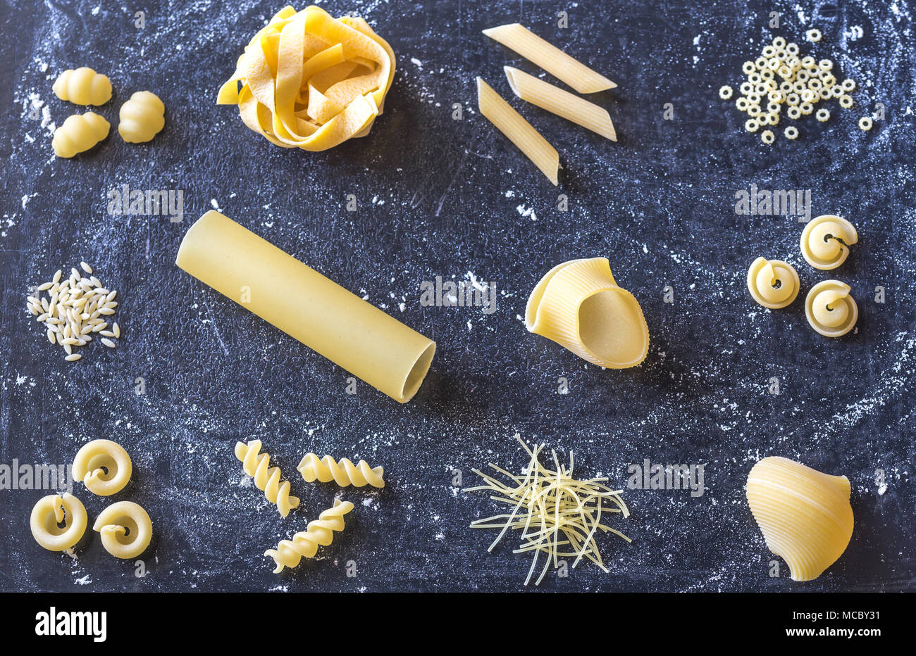 Various types of raw pasta on the dark background Stock Photo - Alamy