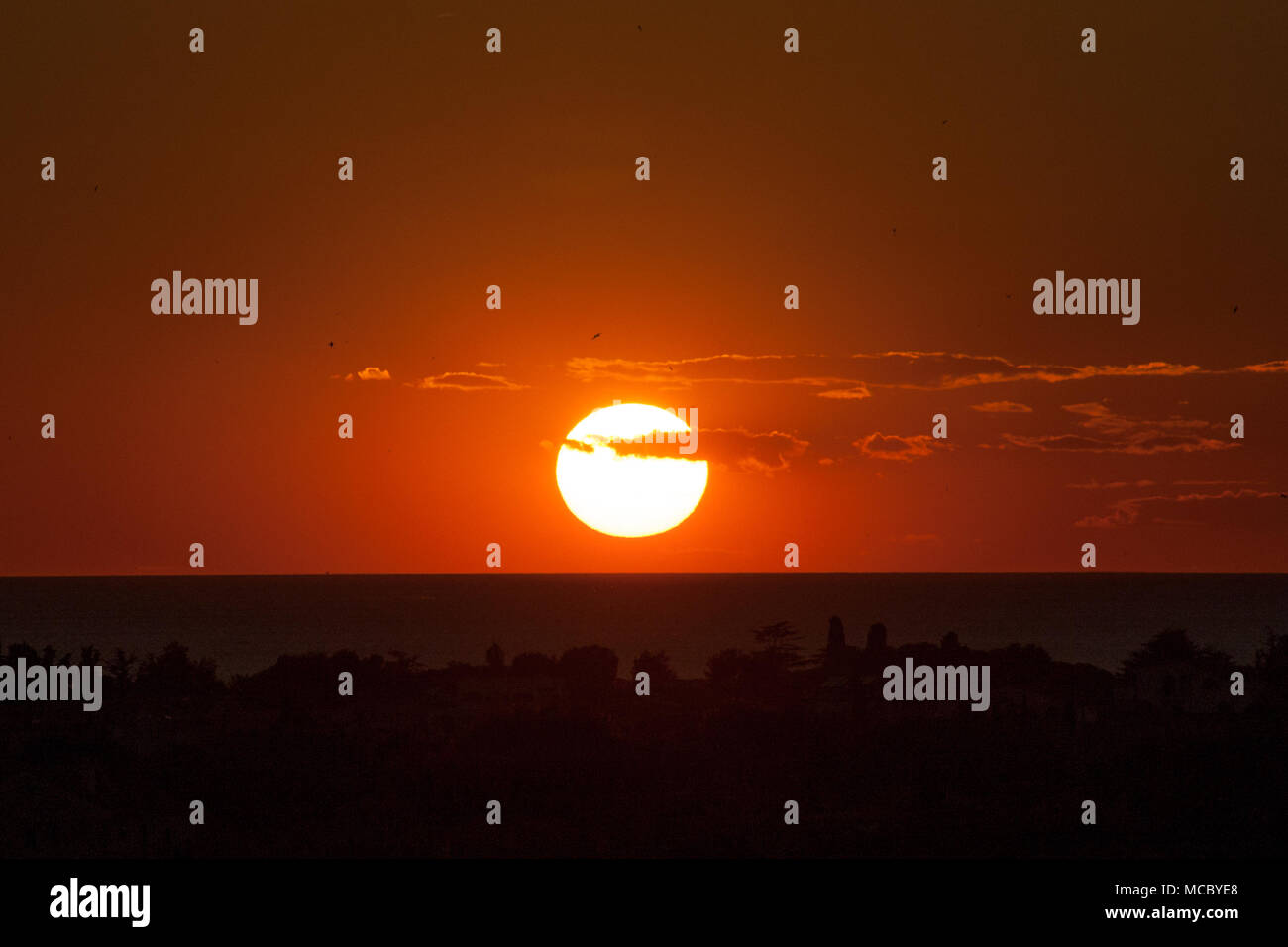 Sun sets in the sea Stock Photo - Alamy